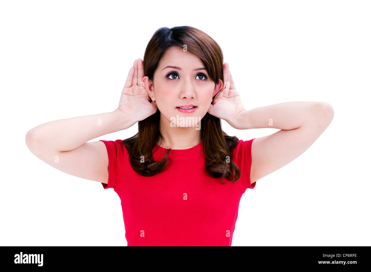 Attractive young woman with hands behind her ears Stock Photo - Alamy