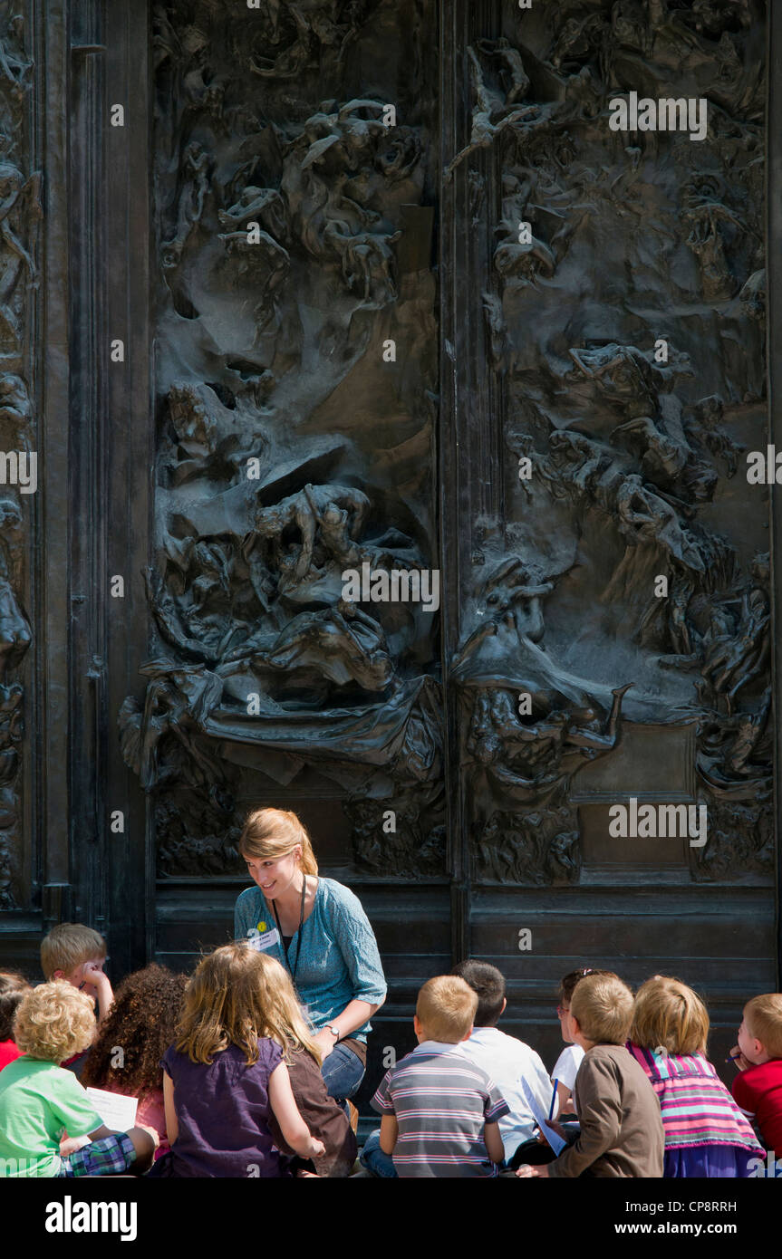 Teacher with a group of students at Auguste Rodin's sculpture The Gates ...