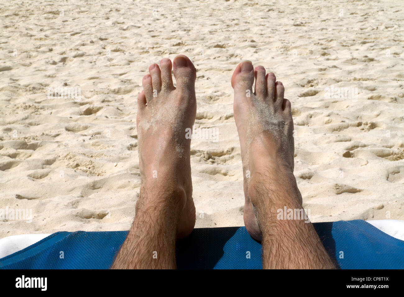 Two feet relaxing on a beach by the ocean Stock Photo - Alamy