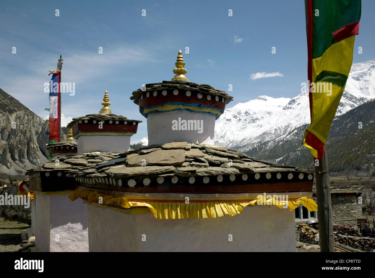 Colour photograph of a chorten and prayer flags, Mustang, Nepal, Asia ...