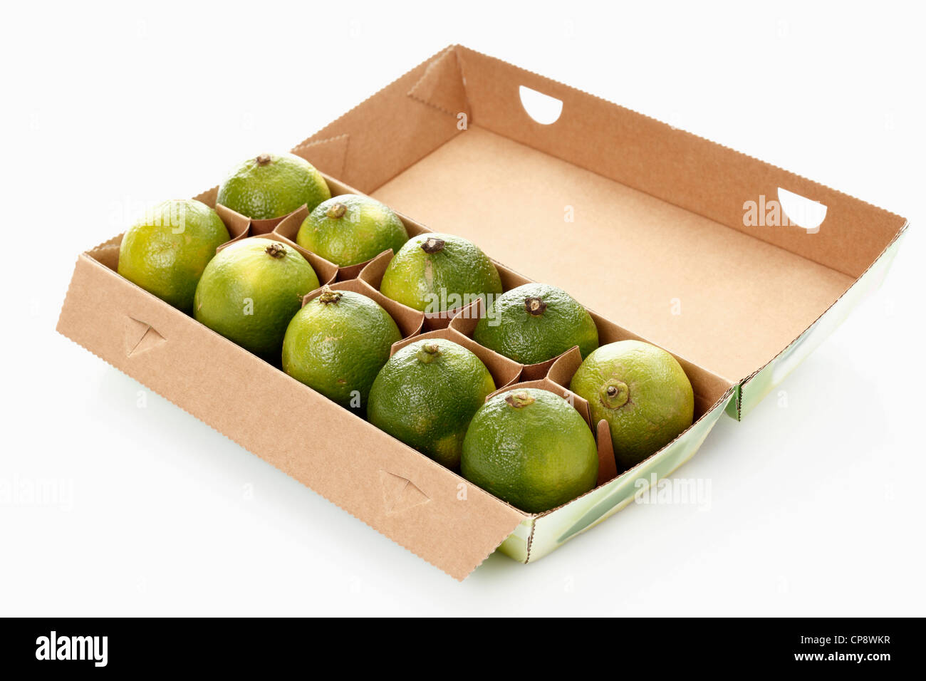 Lime in box on white background Stock Photo - Alamy