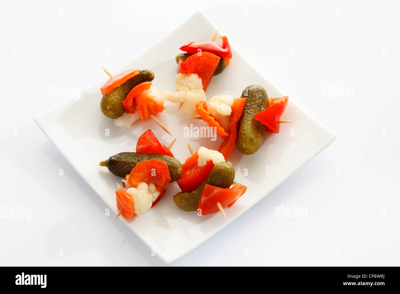 Preserved mixed pickles in plate on white background Stock Photo - Alamy
