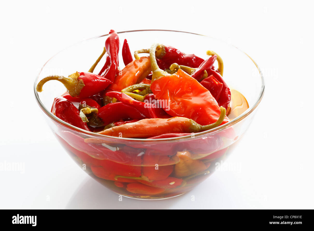 Preserved red pepperoni in glass bowl on white background Stock Photo ...