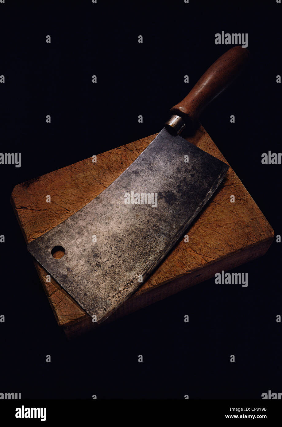 Butcher knife with chopping board on black background Stock Photo - Alamy