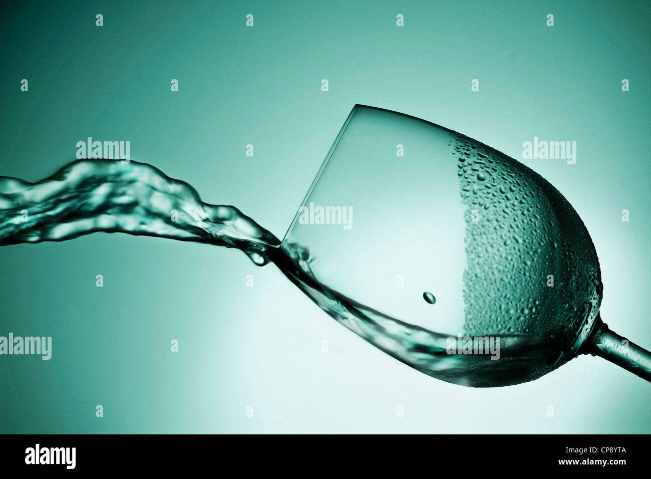 Water splashing out of tilted glass hi-res stock photography and images ...