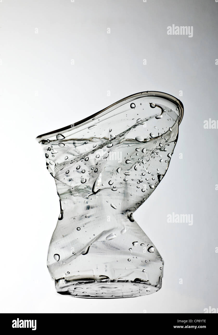 Old plastic cup against grey background Stock Photo - Alamy