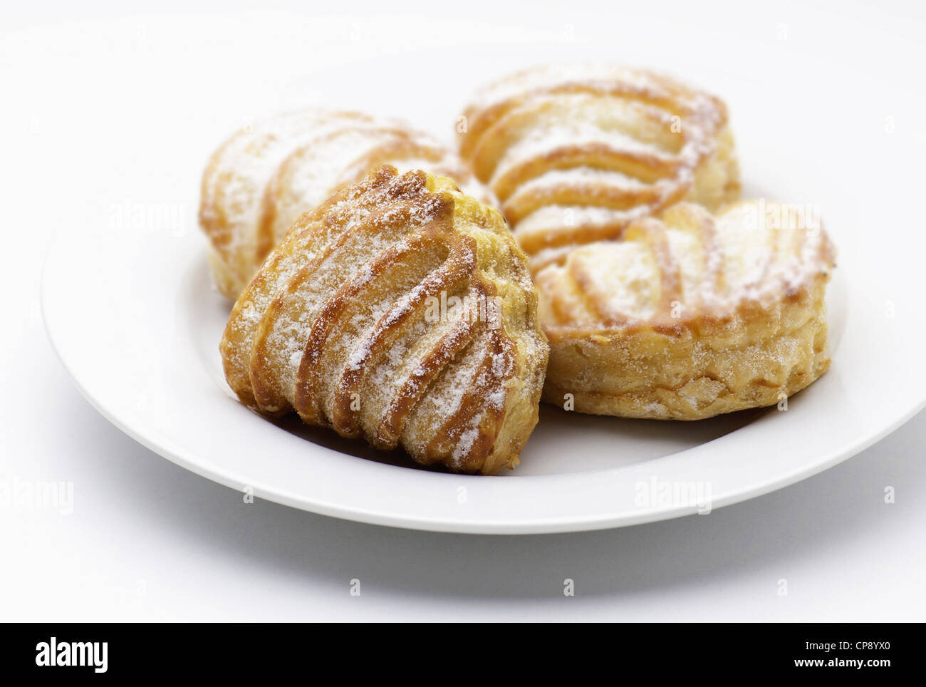 Baked pastry in plate on white background Stock Photo - Alamy