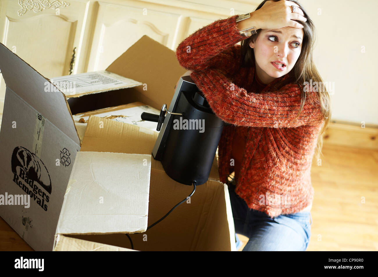 Woman moving house Stock Photo - Alamy