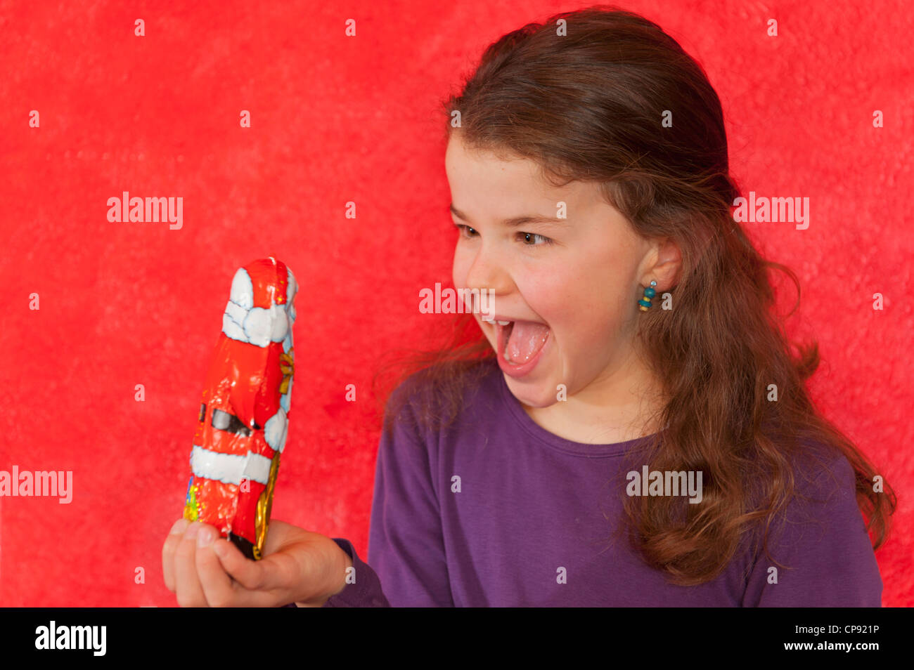 Girl staring at chocolate santa claus Stock Photo - Alamy