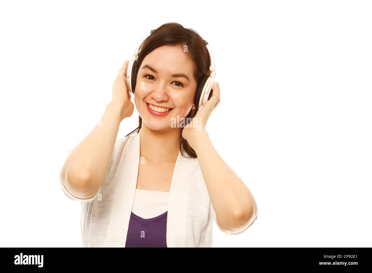 A beautiful young woman with headphones on white background. (Exclusive ...