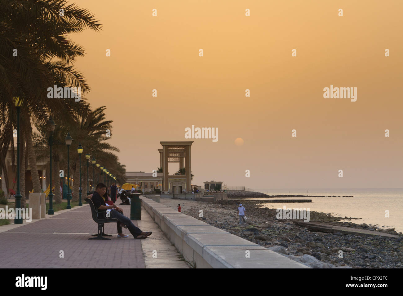 Promenade along the shore of the Arabian Gulf in Kuwait City with local ...