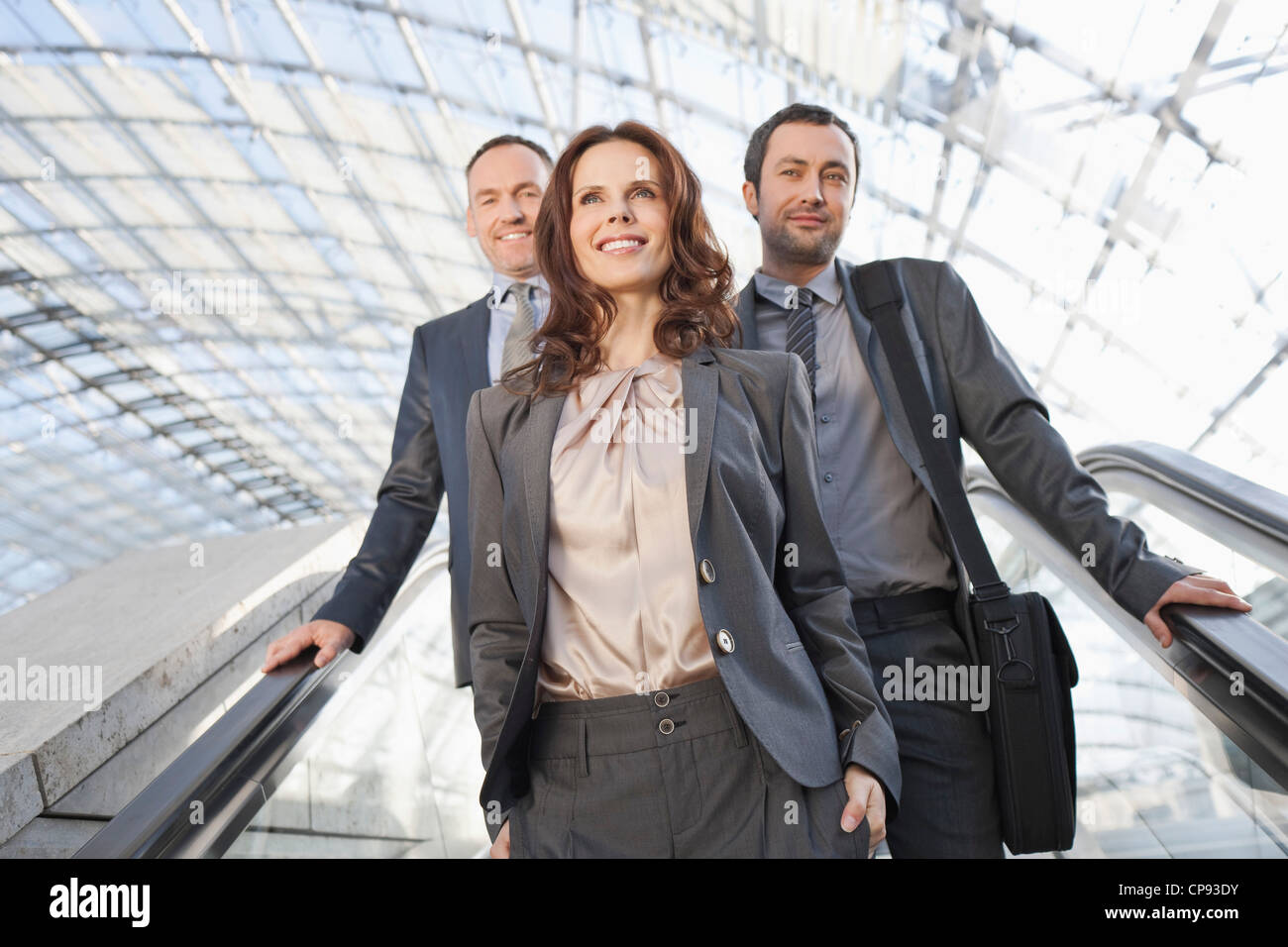 Germany, Leipzig, Business people on escalator, smiling Stock Photo - Alamy