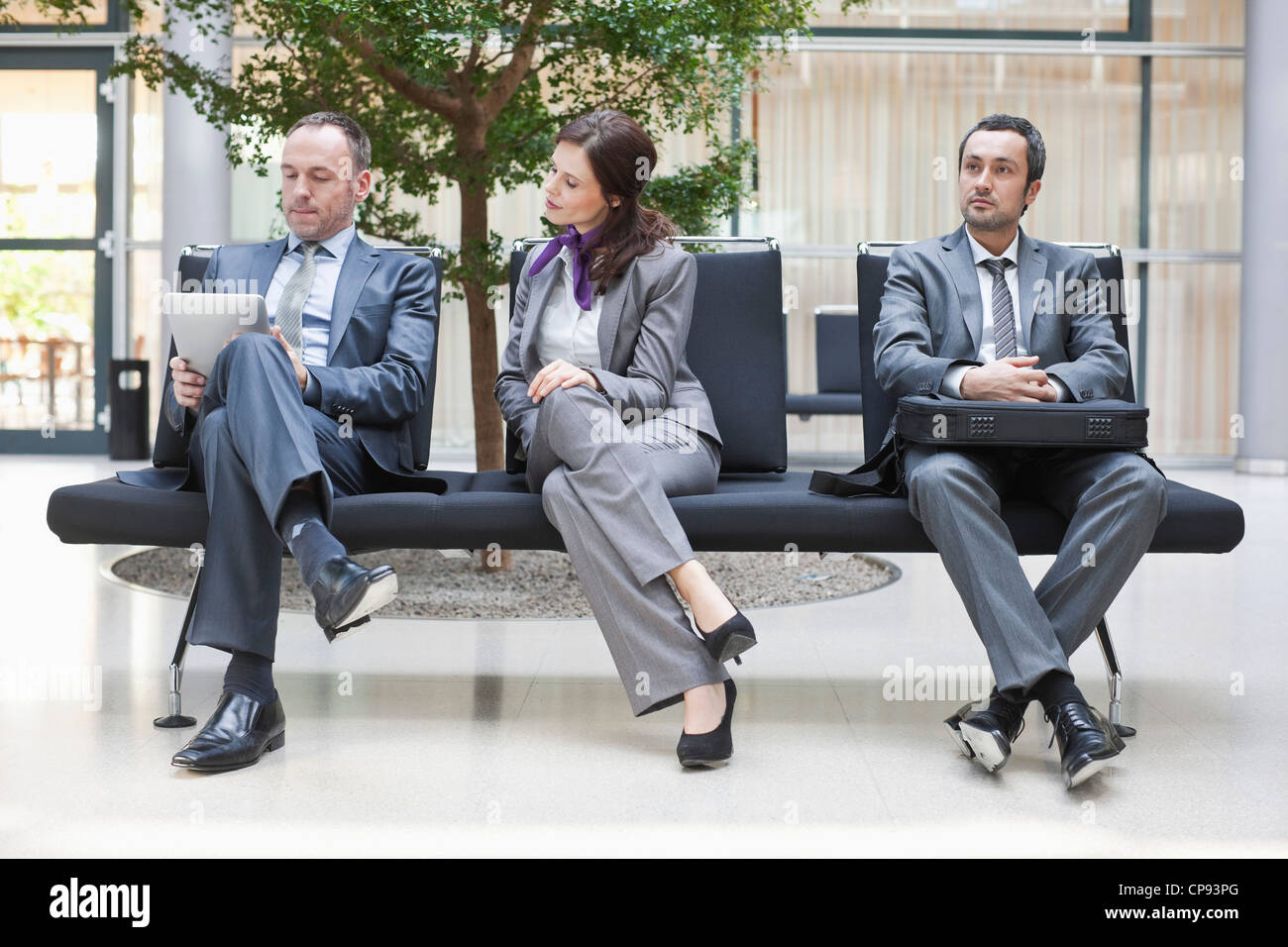 Germany, Leipzig, Business people sitting on bench Stock Photo - Alamy