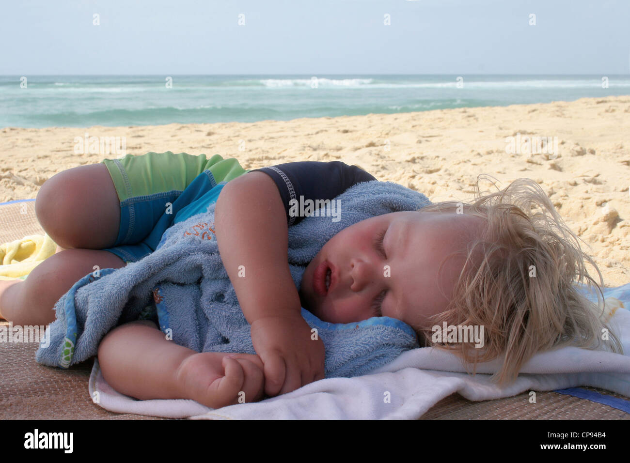 Little boy takes a nap on the beach during the summer holiday Stock ...
