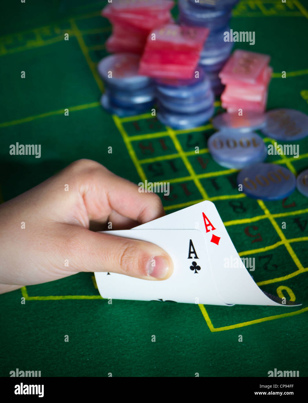 Man to look at two cards in his hand Stock Photo - Alamy