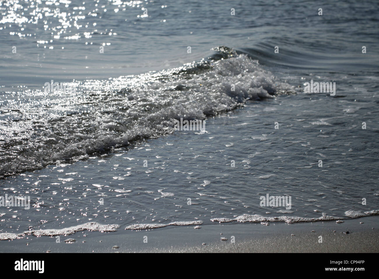 Small breakers on the beach Stock Photo - Alamy