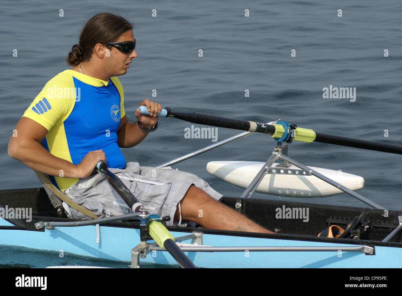 Athlete rowing a boat Stock Photo - Alamy