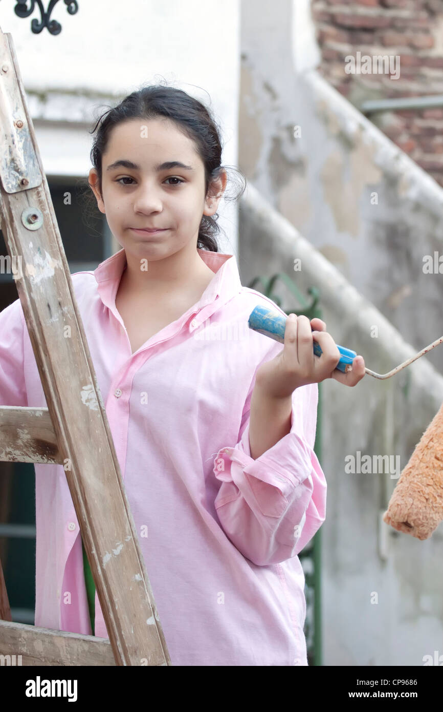 girl with pink shirt painting your home Stock Photo - Alamy