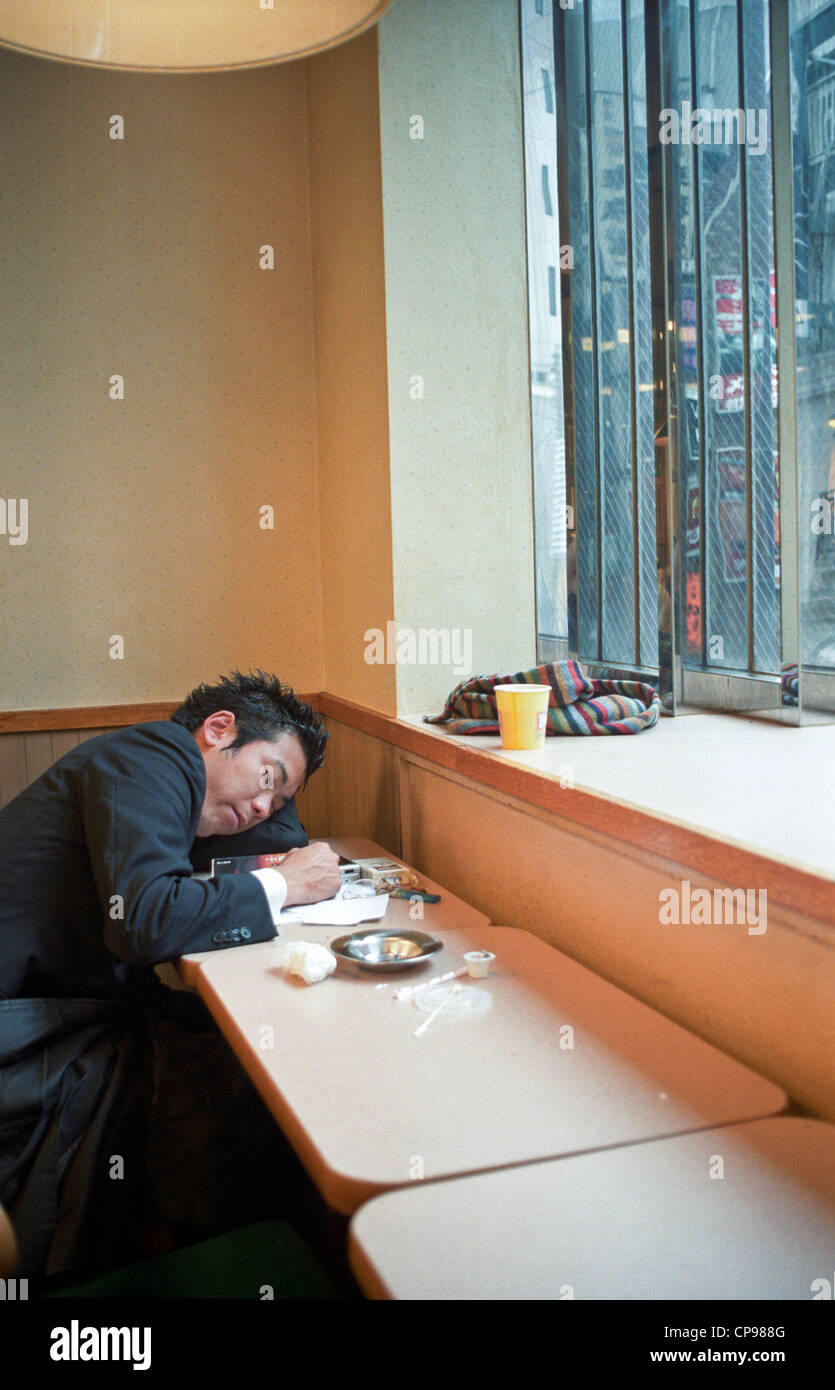 Man sleeping in a a restaurant in Tokyo, Japan Stock Photo - Alamy