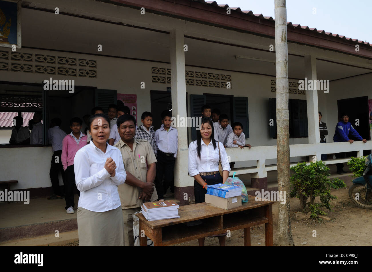 Lao teachers being presented with books and stationary at a school in ...