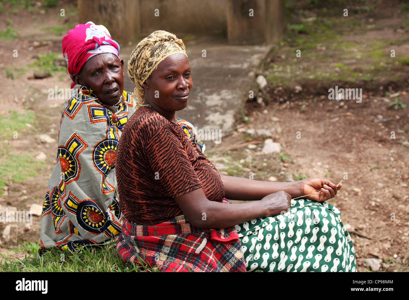 Two Rwandese people take a brief pause from participation in the ...