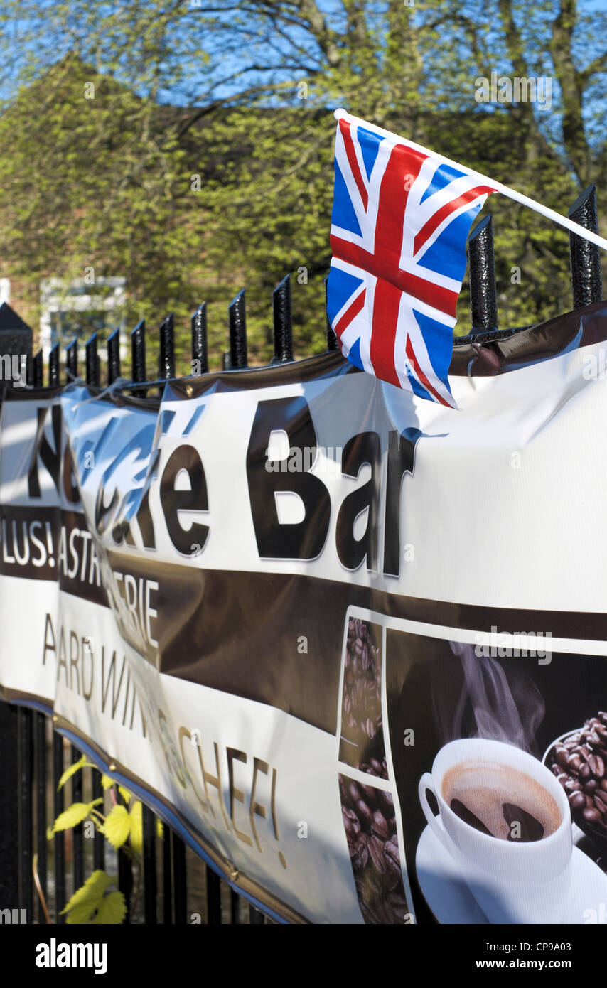 Small British Union Jack flag stuck in railings above an advertising ...