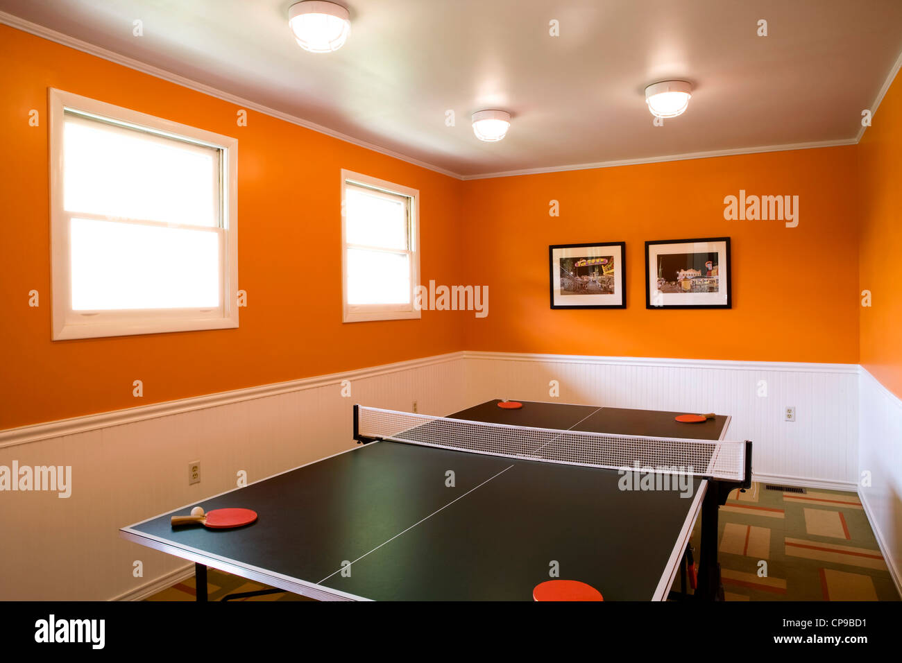 Ping Pong Table and Framed Photos on Wall Stock Photo - Alamy