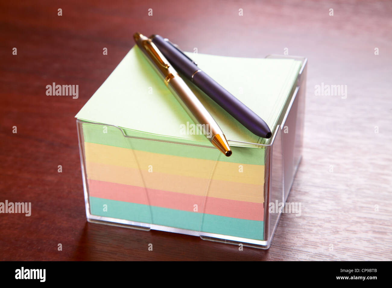 Pile of stickers and two pens on a desk Stock Photo - Alamy