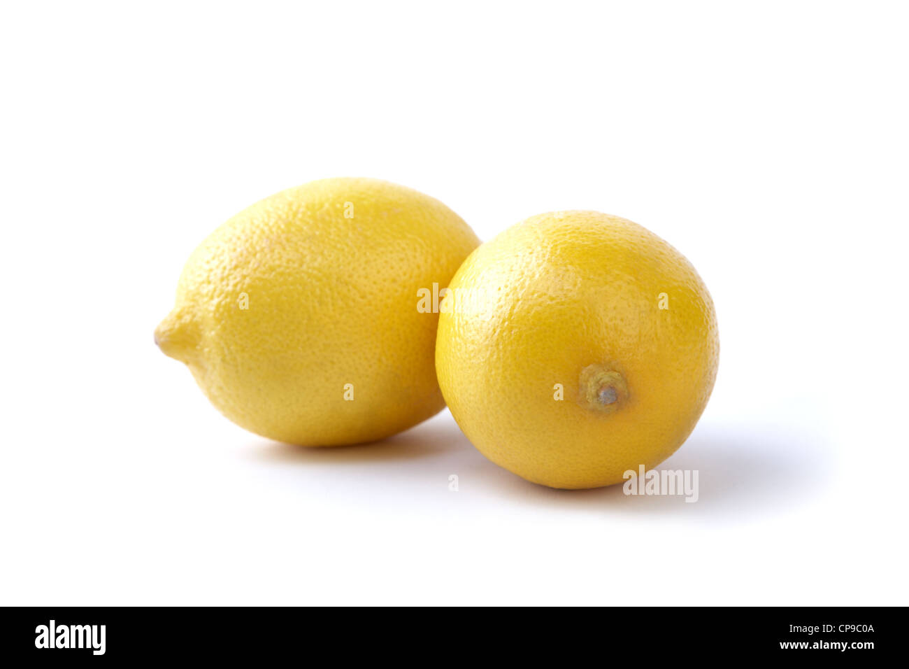 Two whole lemons on a white background Stock Photo - Alamy