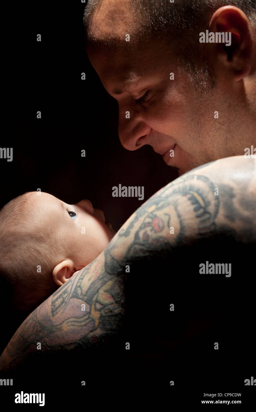 Happy Young Father Holding His Mixed Race Newborn Baby Under Dramatic ...
