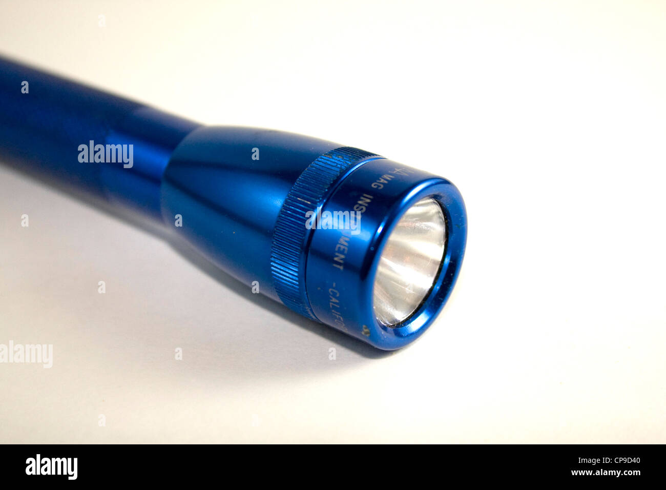 Blue mini flashlight on white background Stock Photo - Alamy