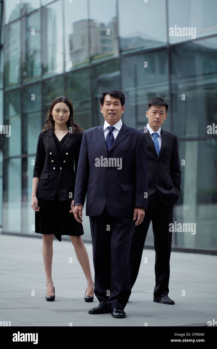 Business people standing in front of a building Stock Photo - Alamy