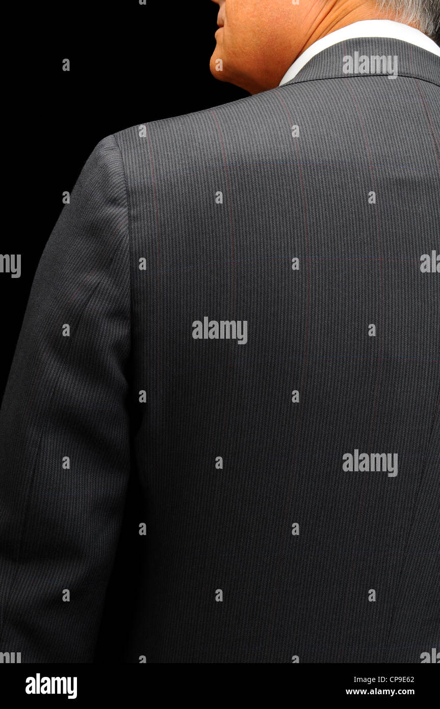 Closeup of a middle aged businessman looking over his shoulder. Seen ...