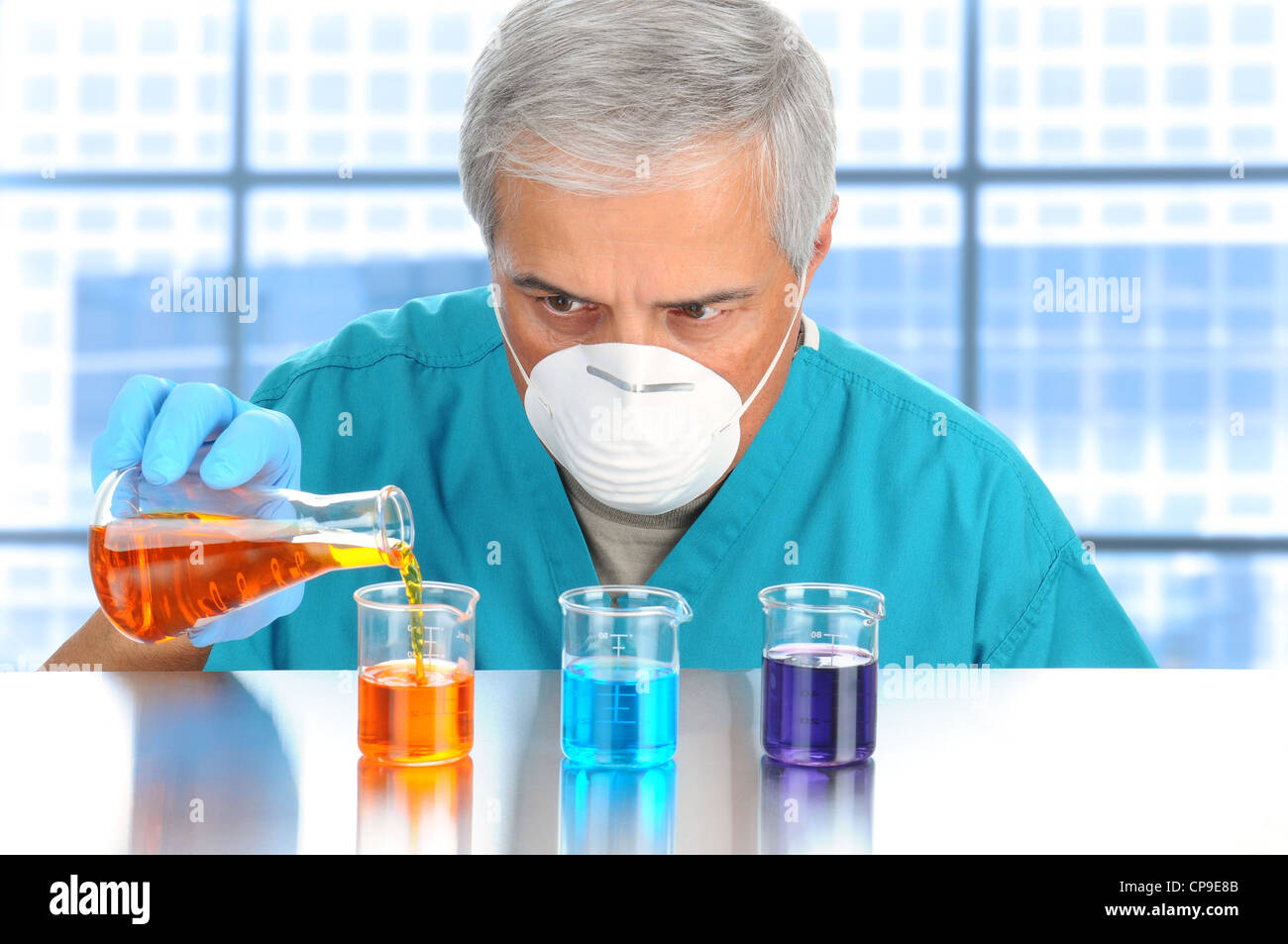 Scientist in modern laboratory pouring and measuring liquids in ...