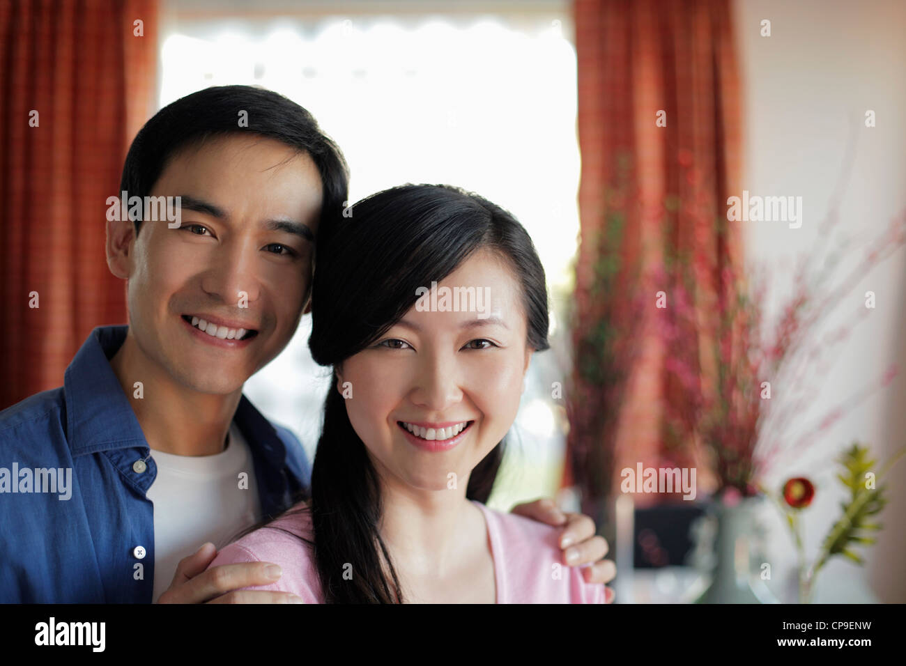 Young couple in their home smiling Stock Photo - Alamy