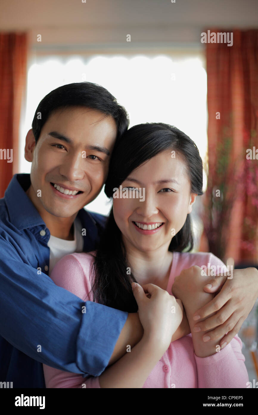 Young couple embracing in their home Stock Photo - Alamy