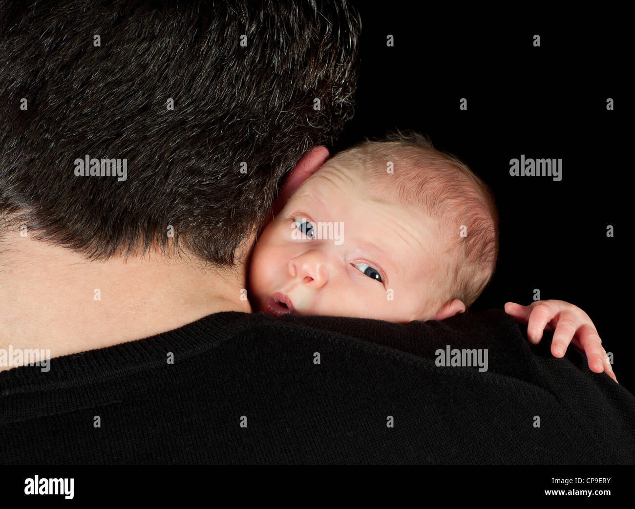Little baby looking over his father's shoulders Stock Photo - Alamy