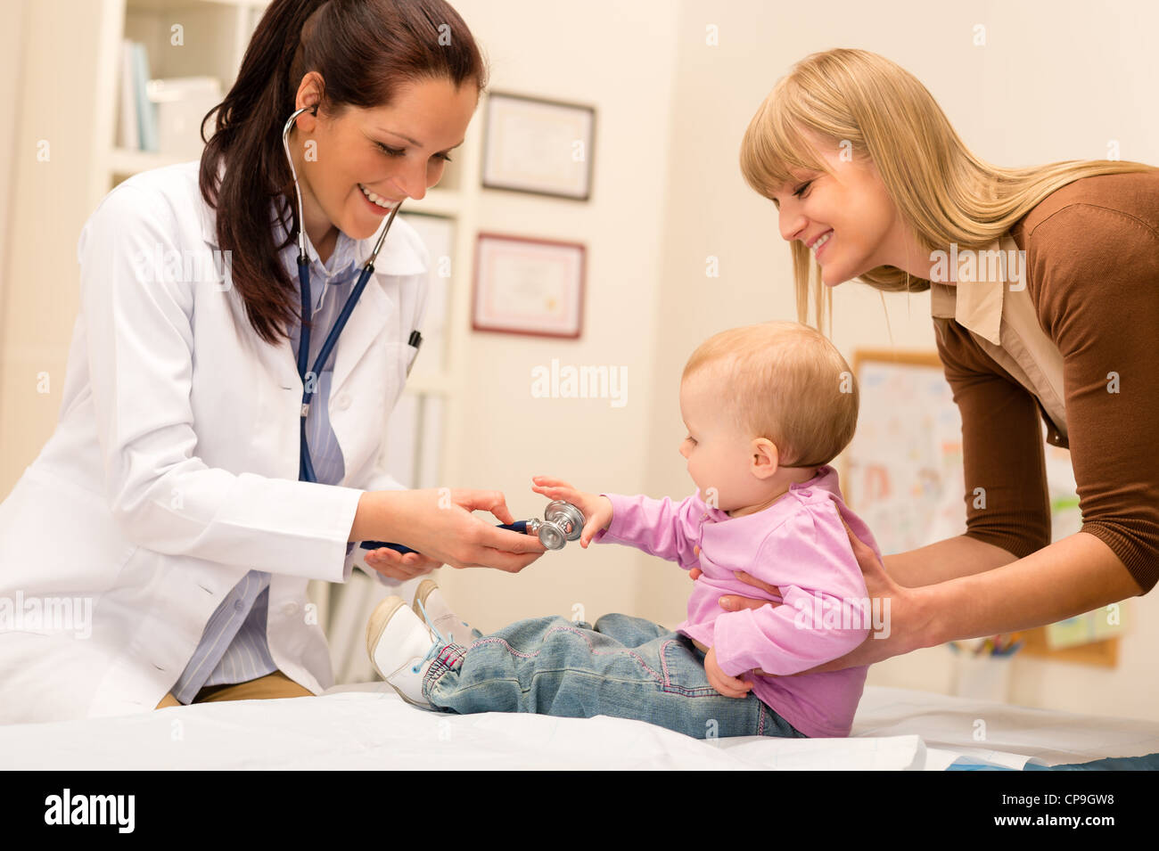 Cute baby being examine by pediatrician with stethoscope Stock Photo ...
