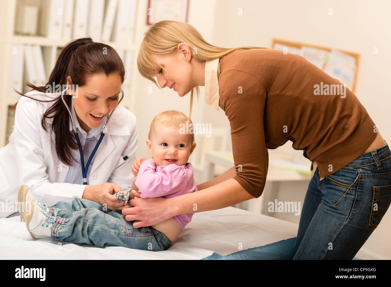 Cute baby being examine by pediatrician with stethoscope mother ...