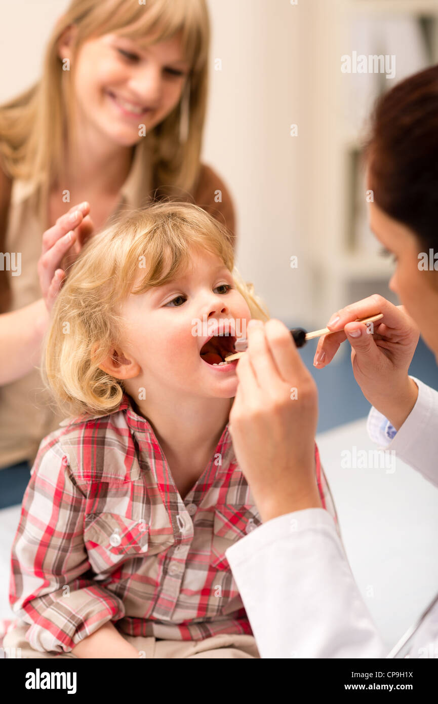 Little girl having throat examination by pediatrician using light pen ...