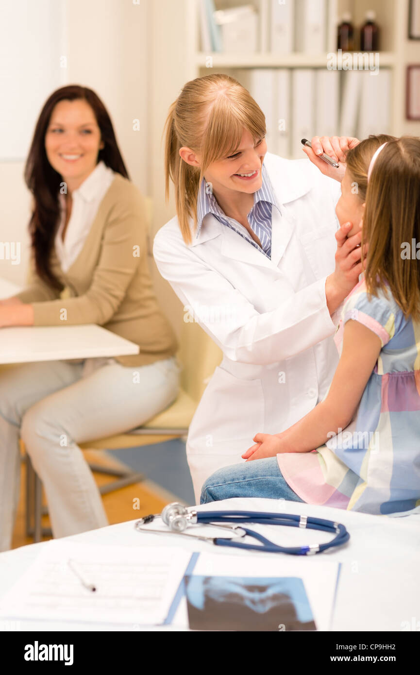 Female pediatrician doing eye check-up to little girl Stock Photo - Alamy