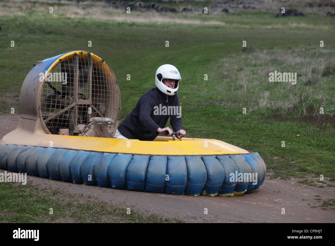 Man riding around a race course on a miniature hovercraft. The novel ...