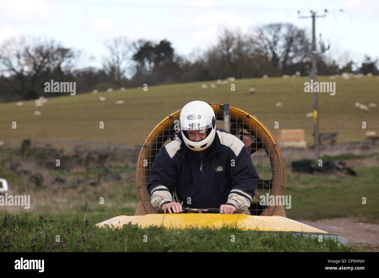Man riding around a race course on a miniature hovercraft. The novel ...
