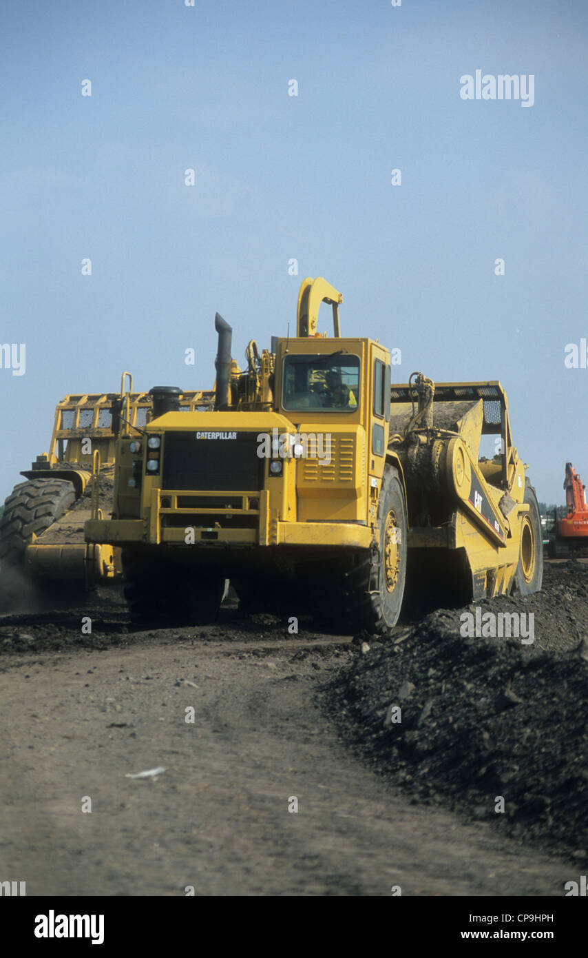 A Caterpillar 631G landscraping construction vehicle employed on a land ...