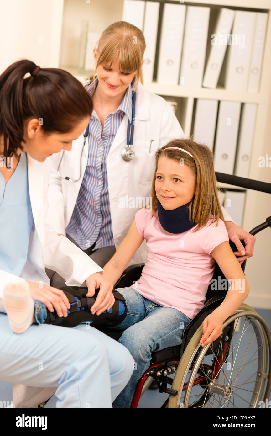 Little injured girl on wheelchair with doctors at medical office Stock ...