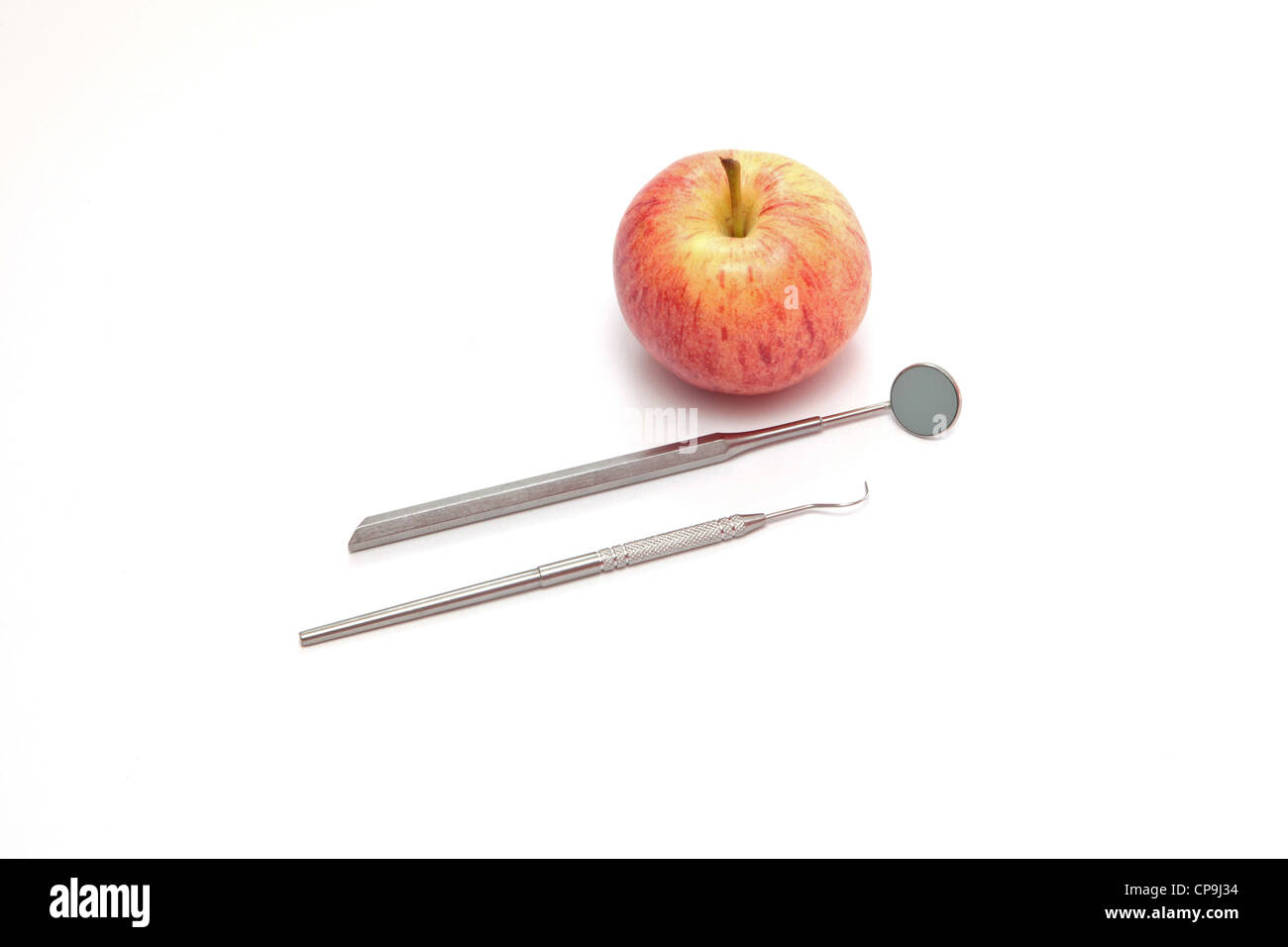 An apple and dentist tools Stock Photo - Alamy