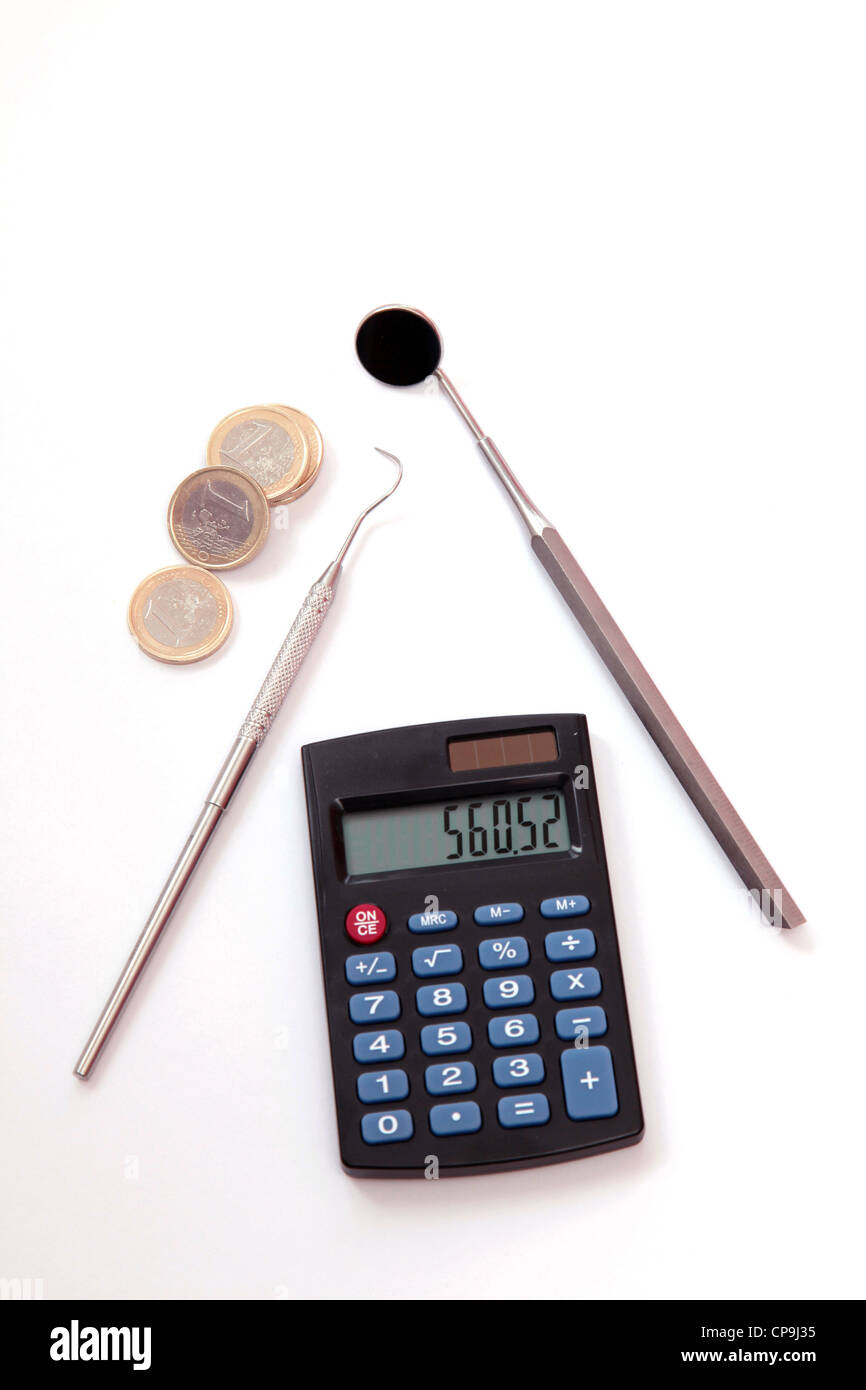 Money a calculator and dental tools Stock Photo - Alamy