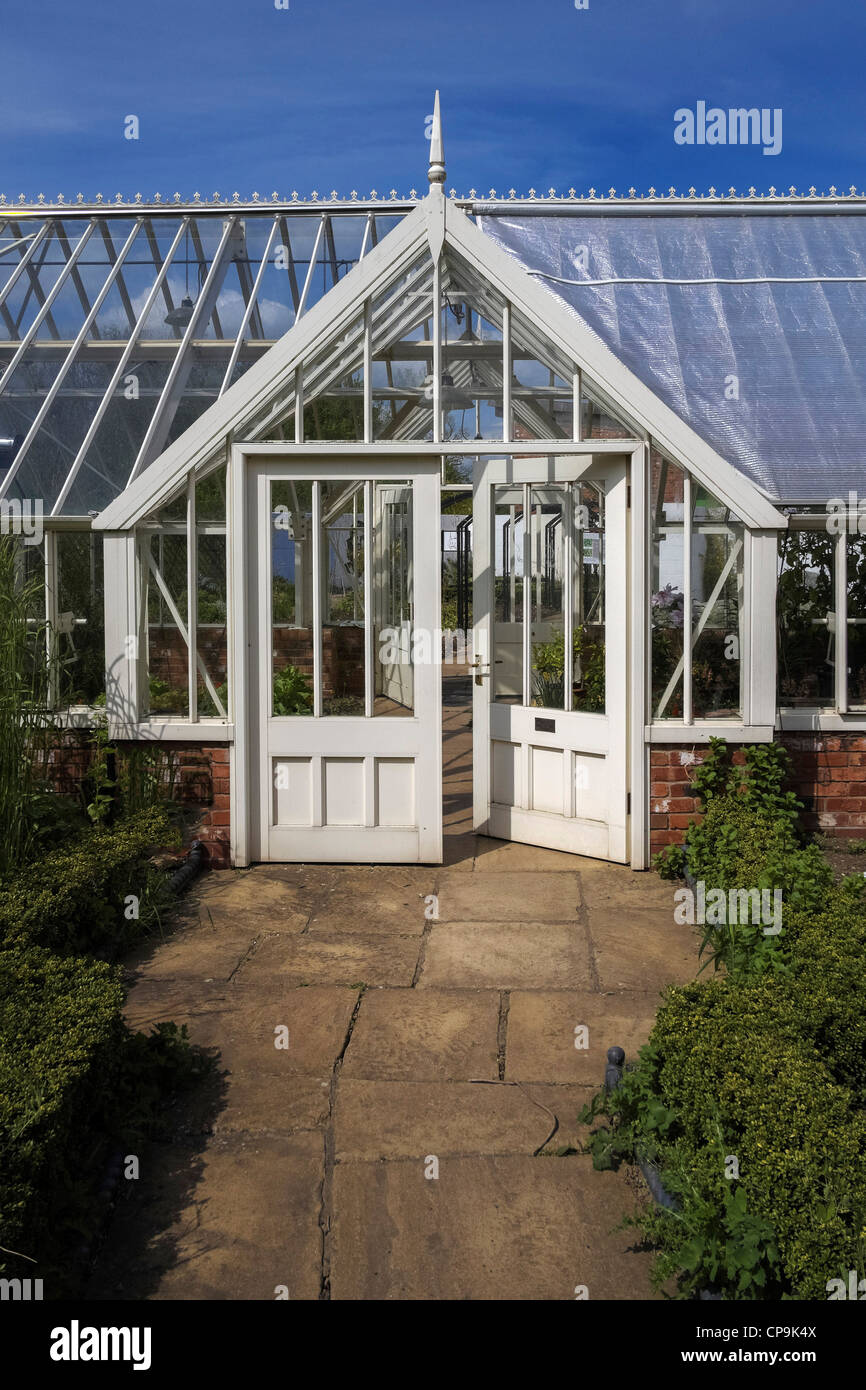 conservatory tables chairs plants room in house next to garden Stock ...