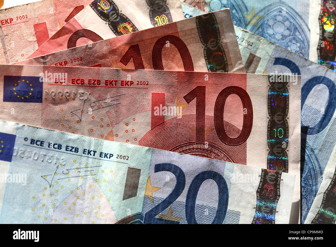 Notes and coins of the euro, the official currency of the eurozone ...