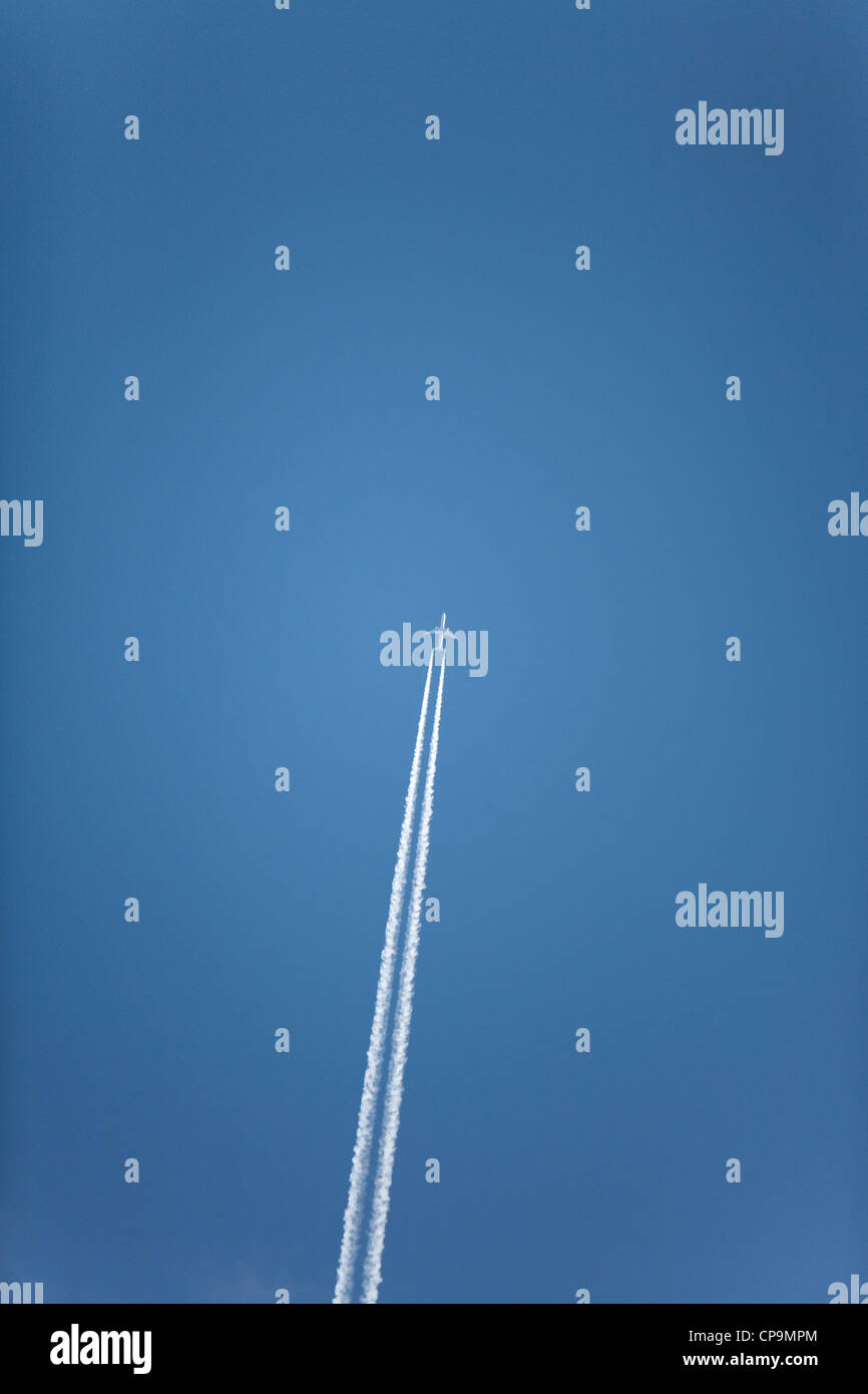 An airliner producing contrails or vapour trails in the sky Stock Photo ...